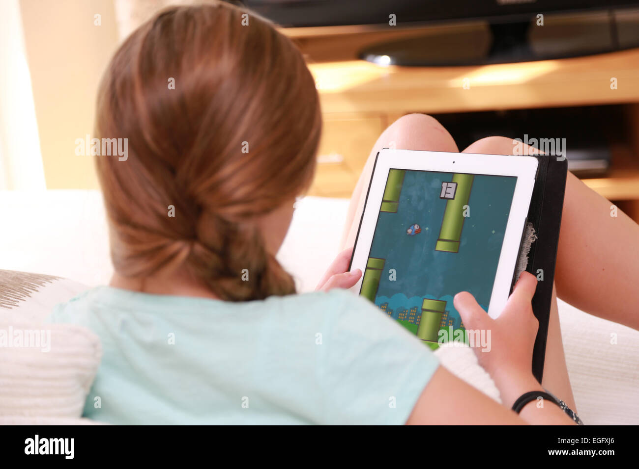Girl playing on a tablet hi-res stock photography and images - Alamy