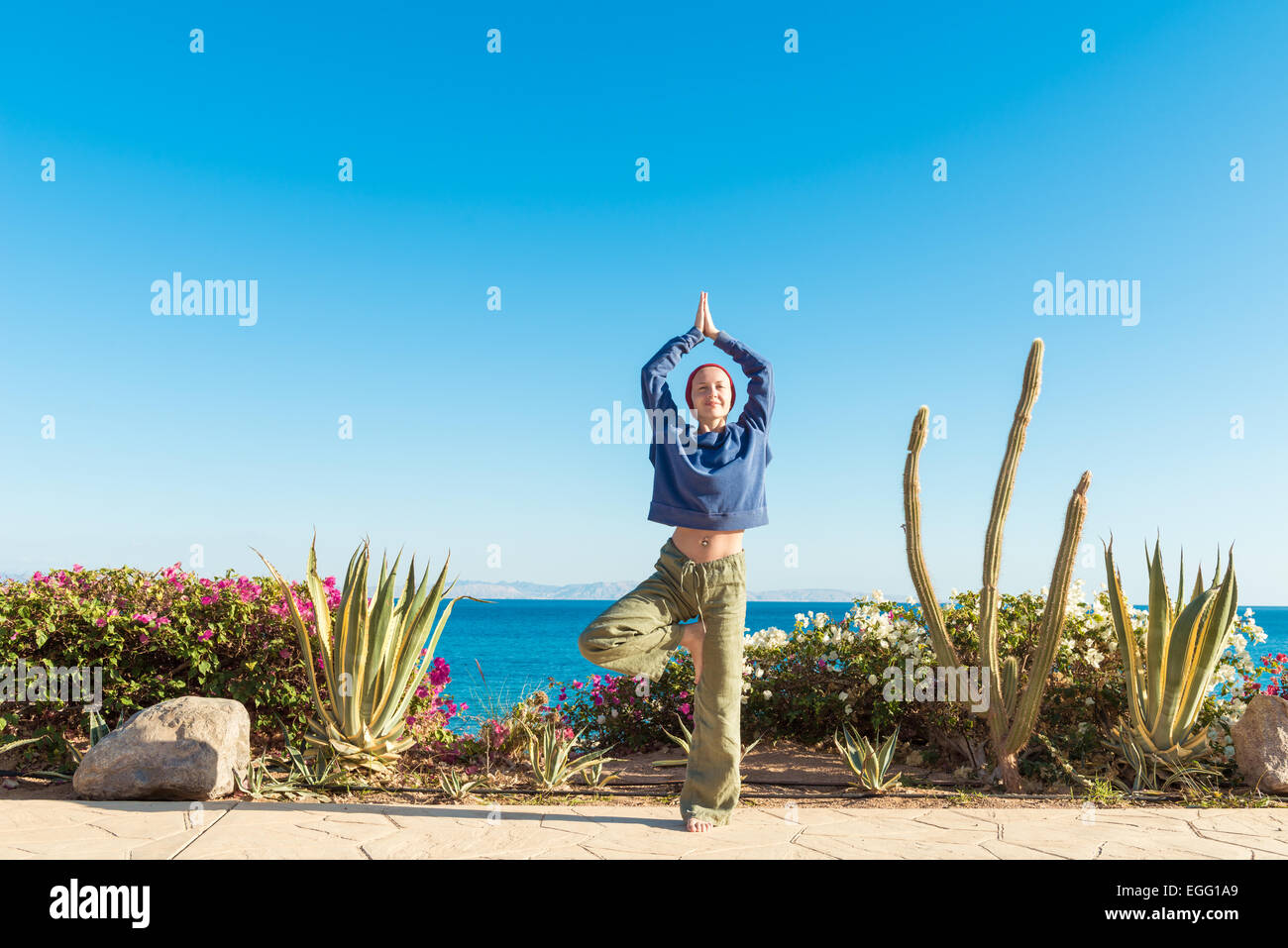 Woman doing yoga asana at sea resort Stock Photo - Alamy