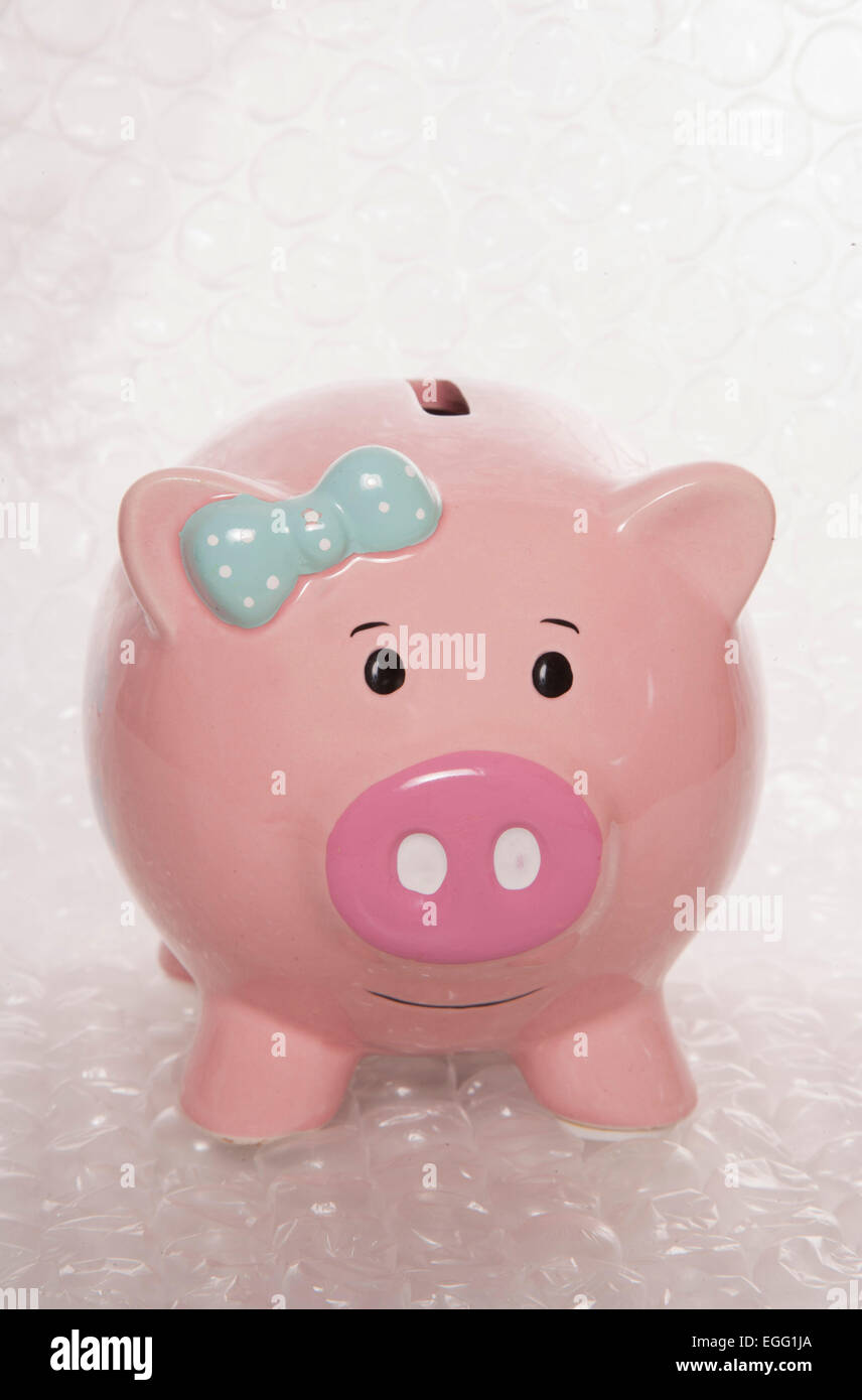 fragile piggy bank on bubble wrap Stock Photo - Alamy