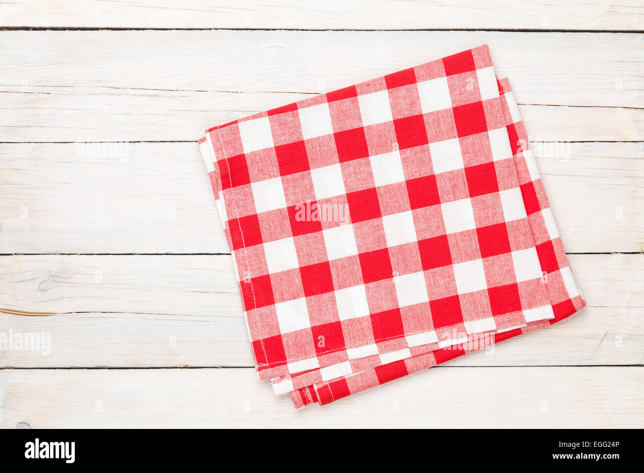 Red towel over wooden kitchen table. View from above with copy space ...
