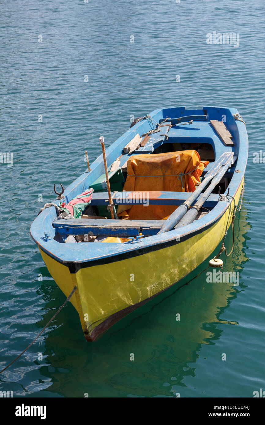 Old wooden yellow rowing boat on the water. Vertical shot Stock Photo ...