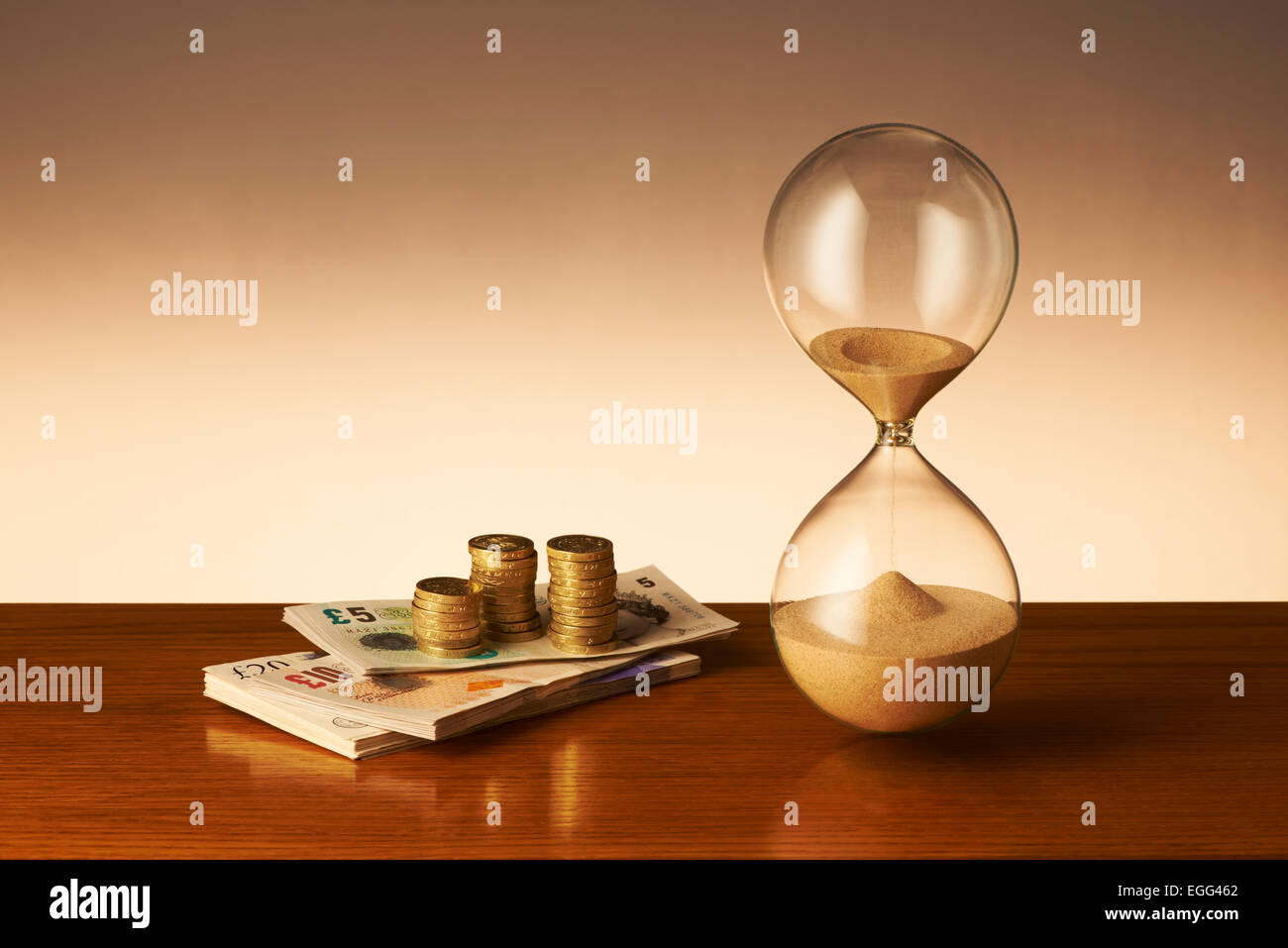 Hour Glass with Money Stock Photo - Alamy