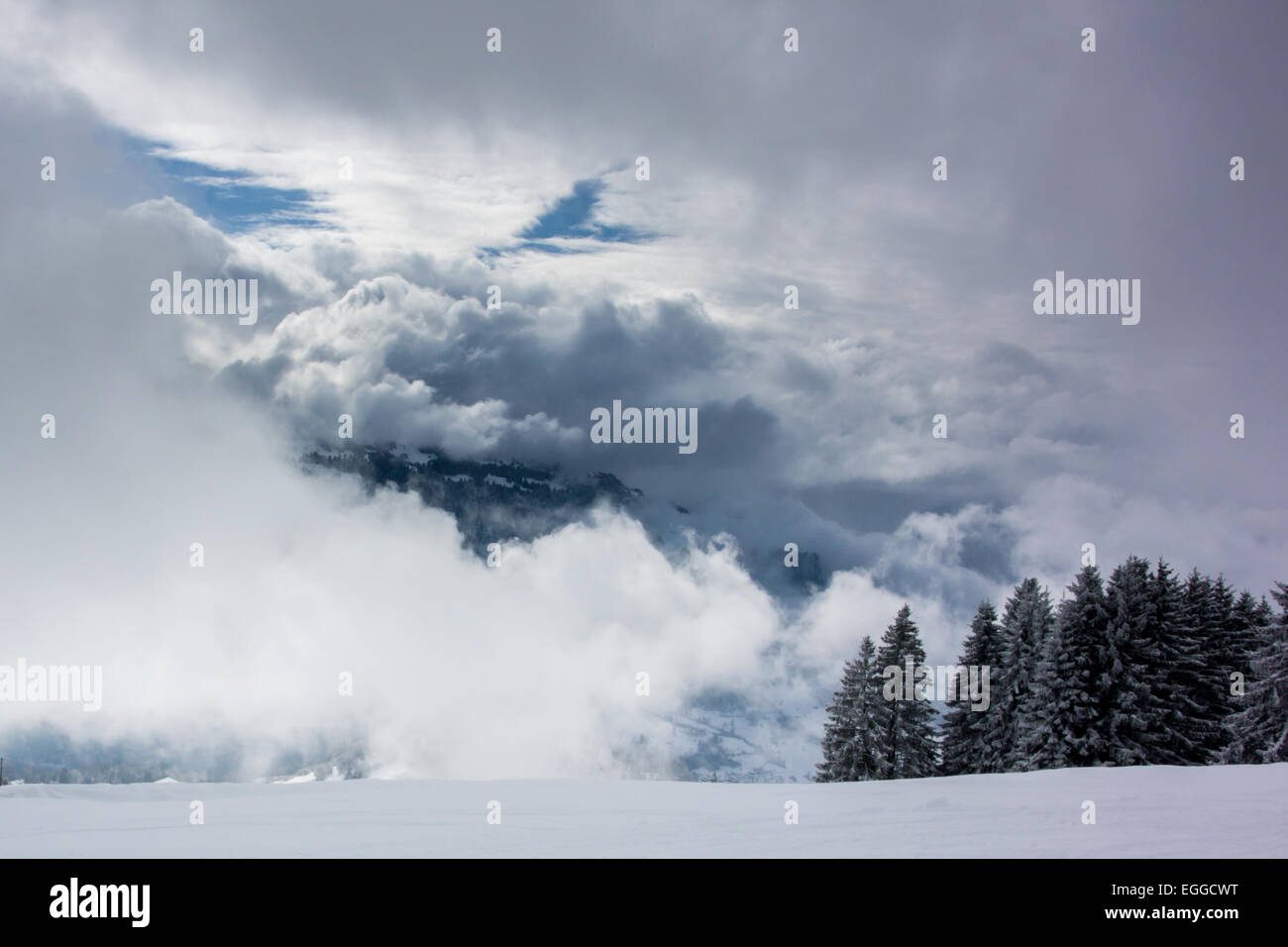 Clouds on a snowy landscape Stock Photo - Alamy