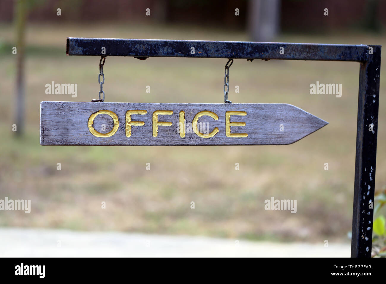Wooden arrow sign with the inscription office photographed closeup ...