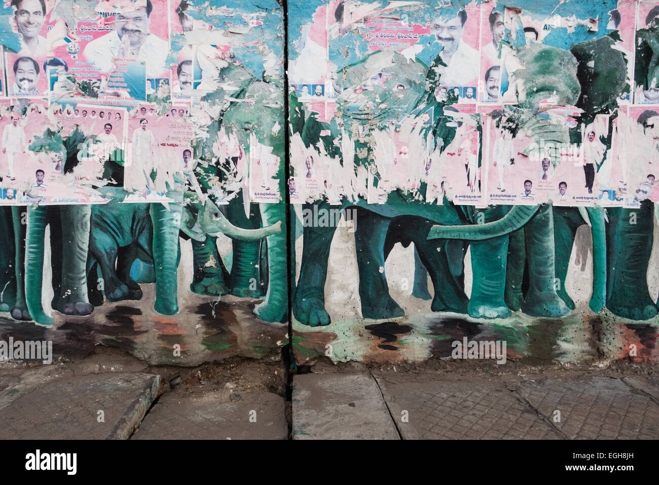 political posters pasted on a wall painting on the streets of Hyderabad ...