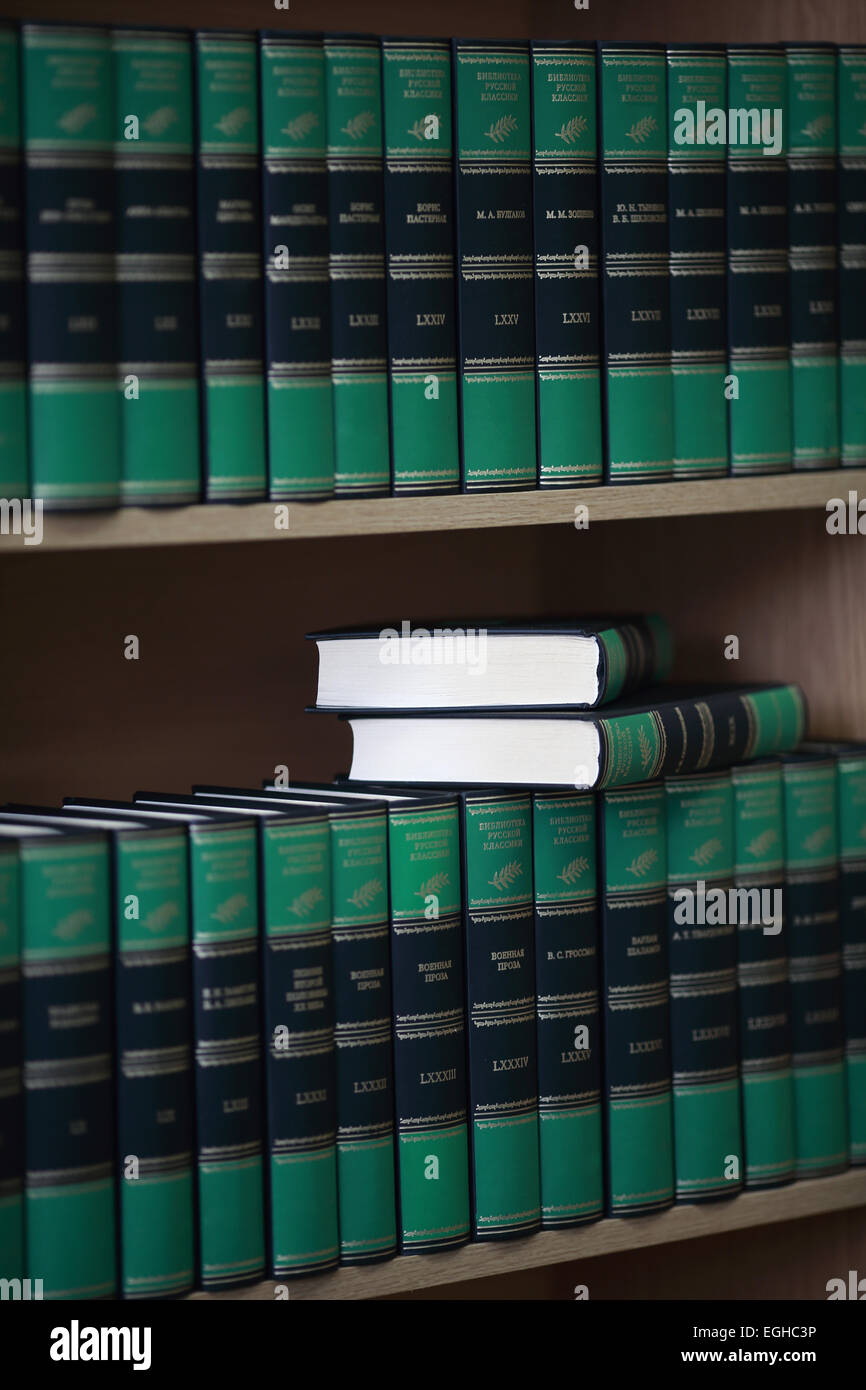 bookshelf with volumes of books in the same green cover Stock Photo - Alamy