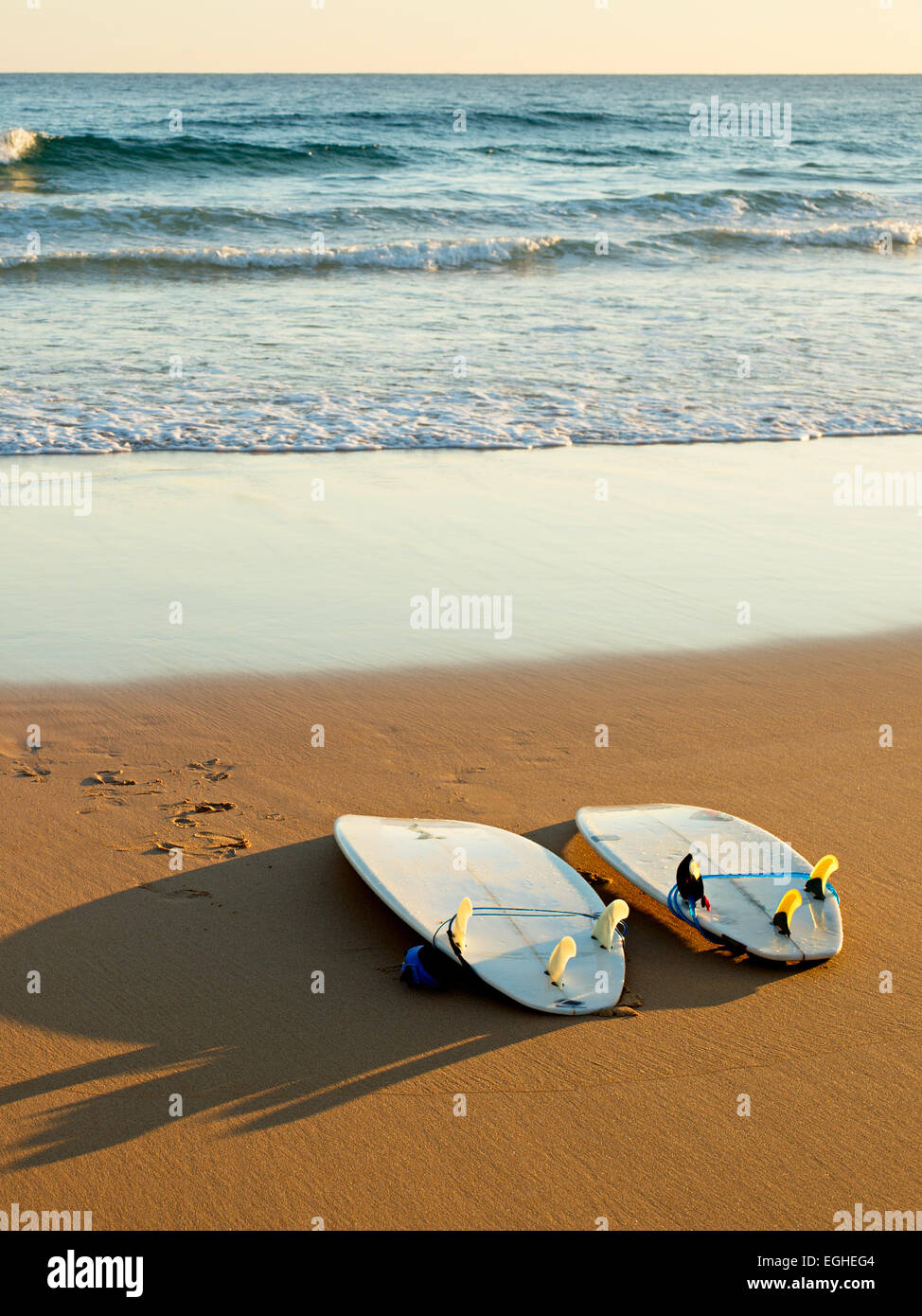 Surfboard In Sand And Sunset