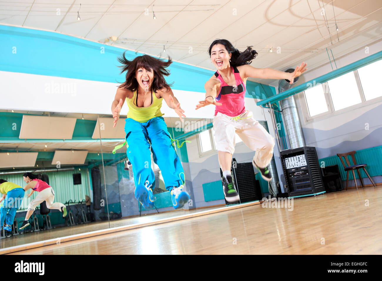 group of women in sport dress jumping at fitness dance excercise or ...