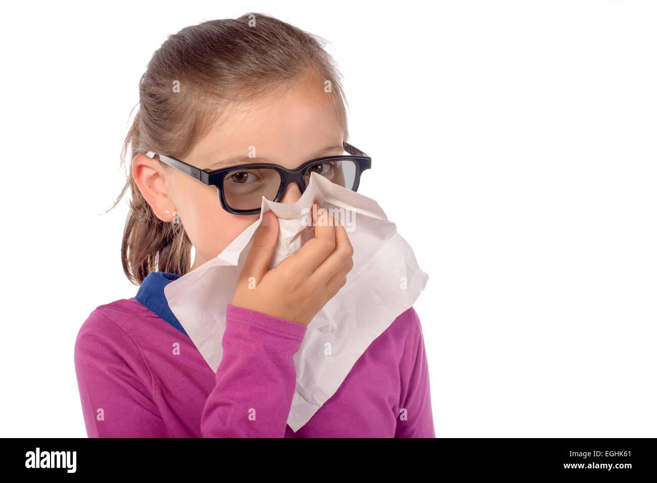 a little schoolgirl has a cold on white background Stock Photo - Alamy