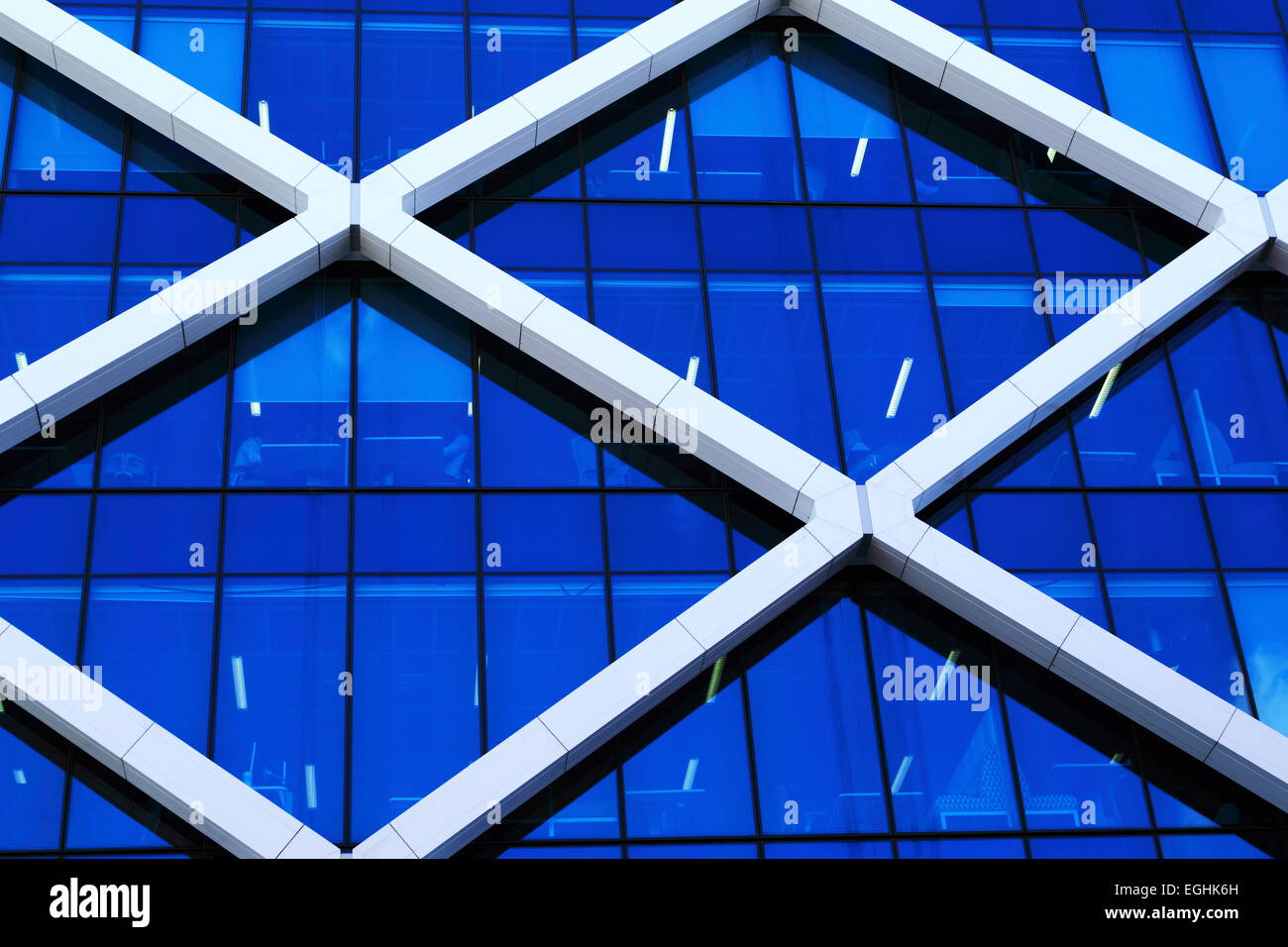 Interesting architectural sculpture skirts the blue glass of a building ...