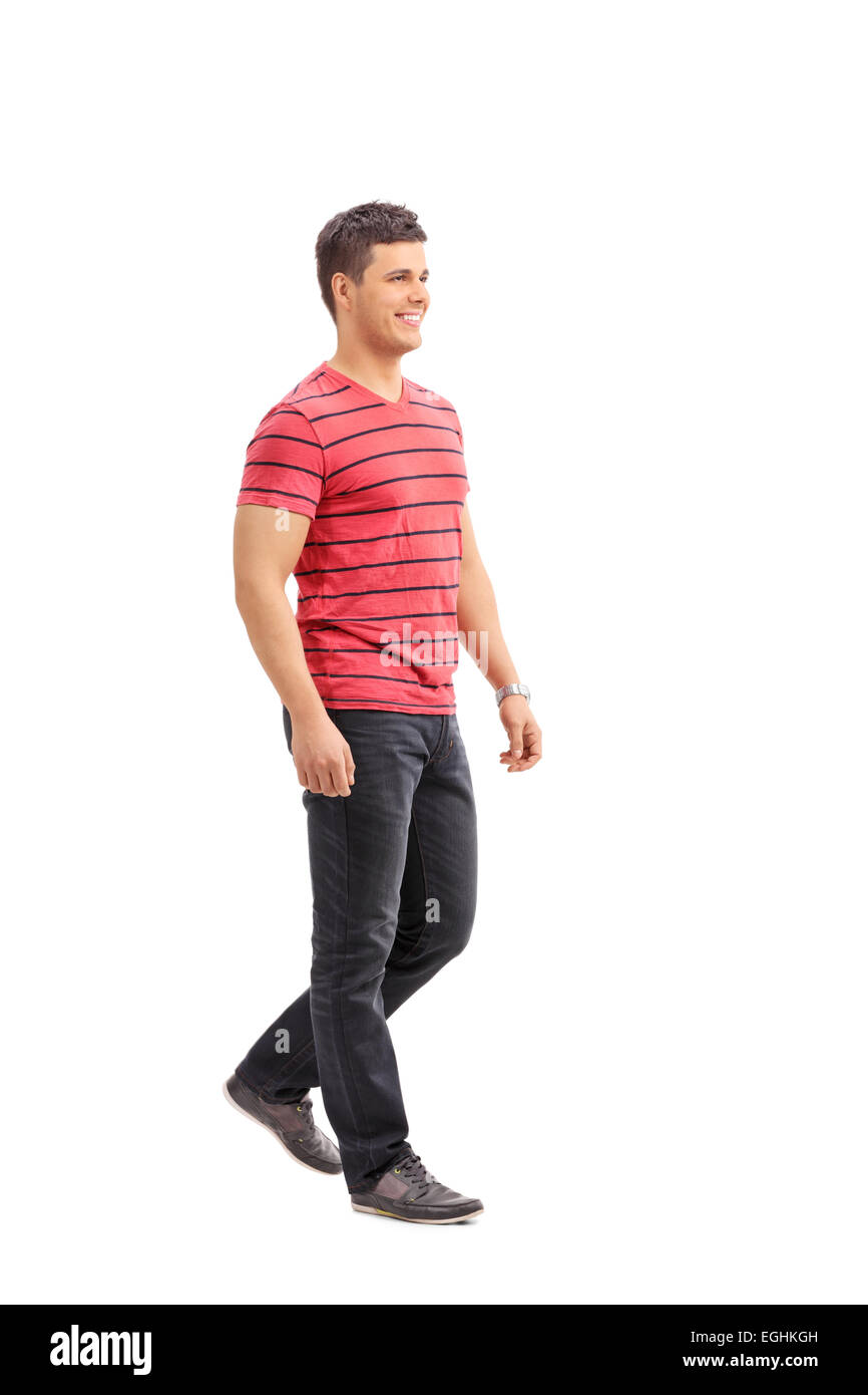 Full length portrait of a young casual man walking isolated on white ...