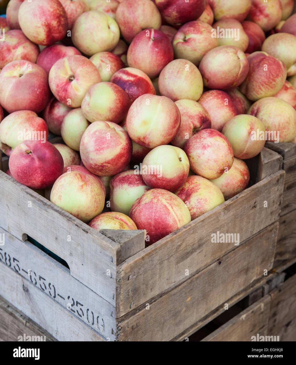 Box full of ripe nectarines offered at market stall Stock Photo - Alamy