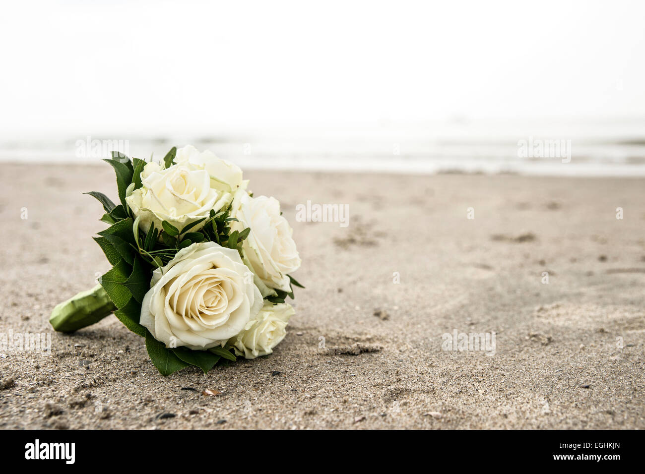 Bridal bouquet of white roses lying on a North Sea beach Stock Photo ...