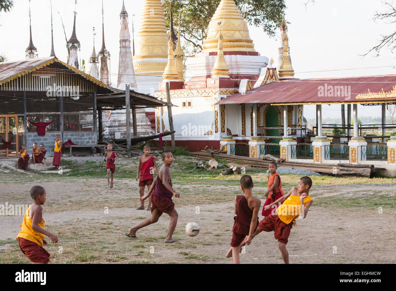 Buddhist novice boy monks playing football in their robes outdoors at ...