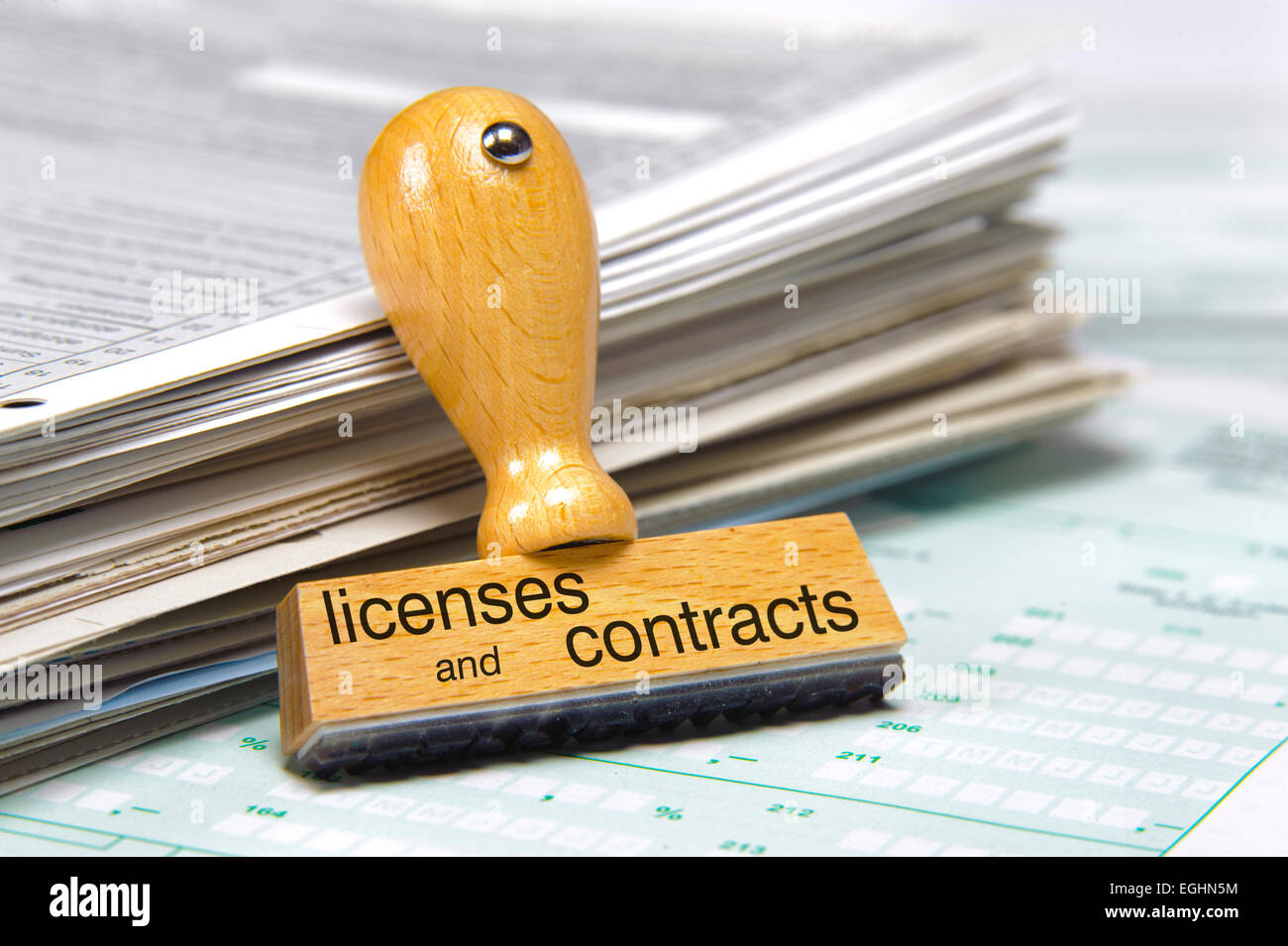 licenses and contracts printed on rubber stamp over documents Stock ...