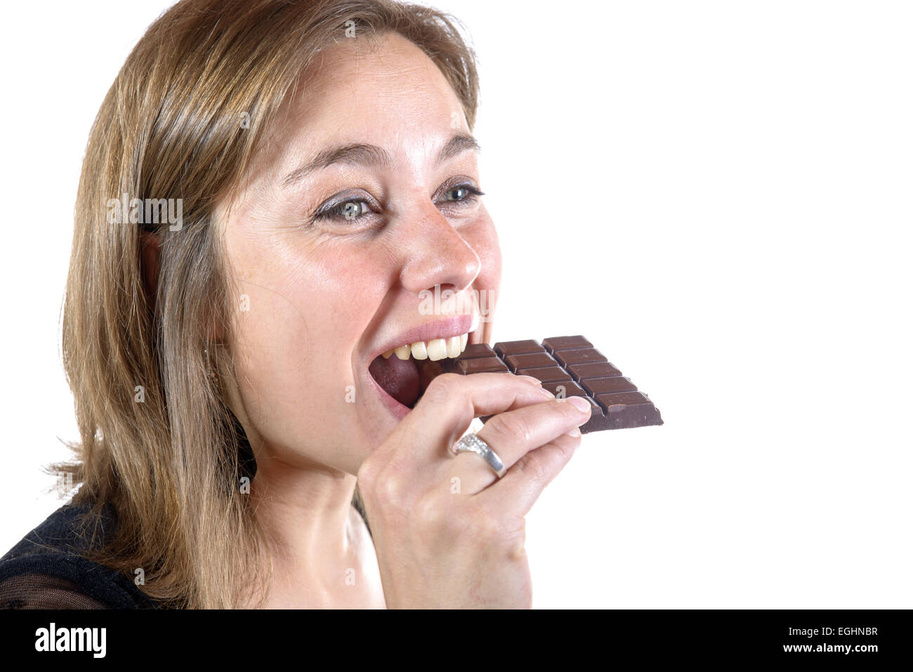 young woman eating chocolate on white background Stock Photo - Alamy