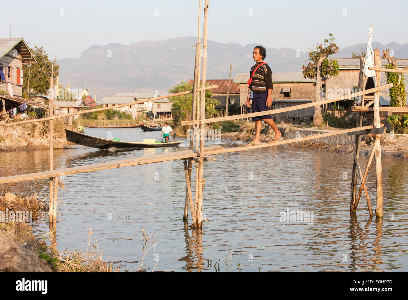 Crossing over waterway,canal at Inle Lake,on a bridge of basic ...