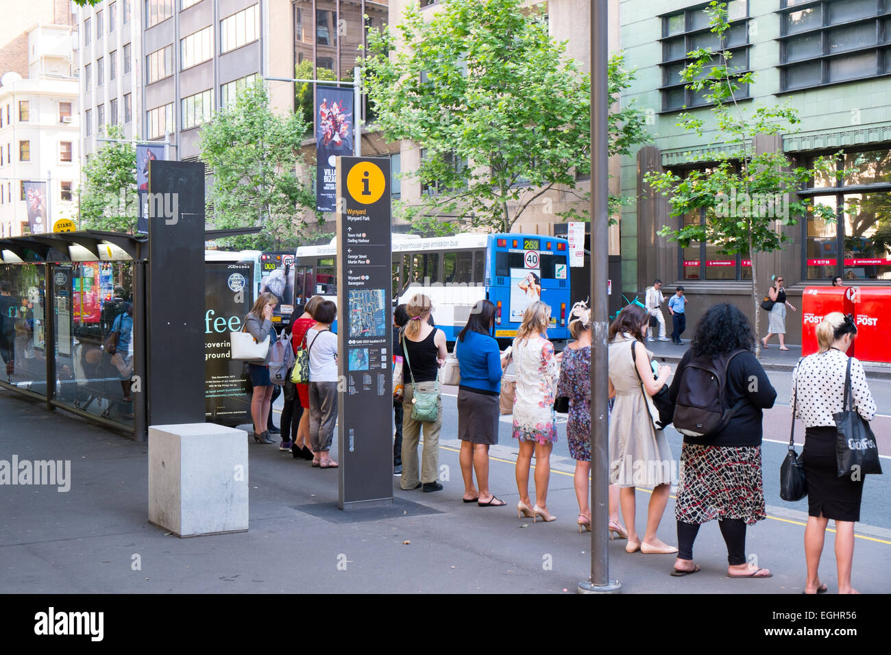 Sydney city centre CBD people stood at a Sydney bus stop waiting for a ...