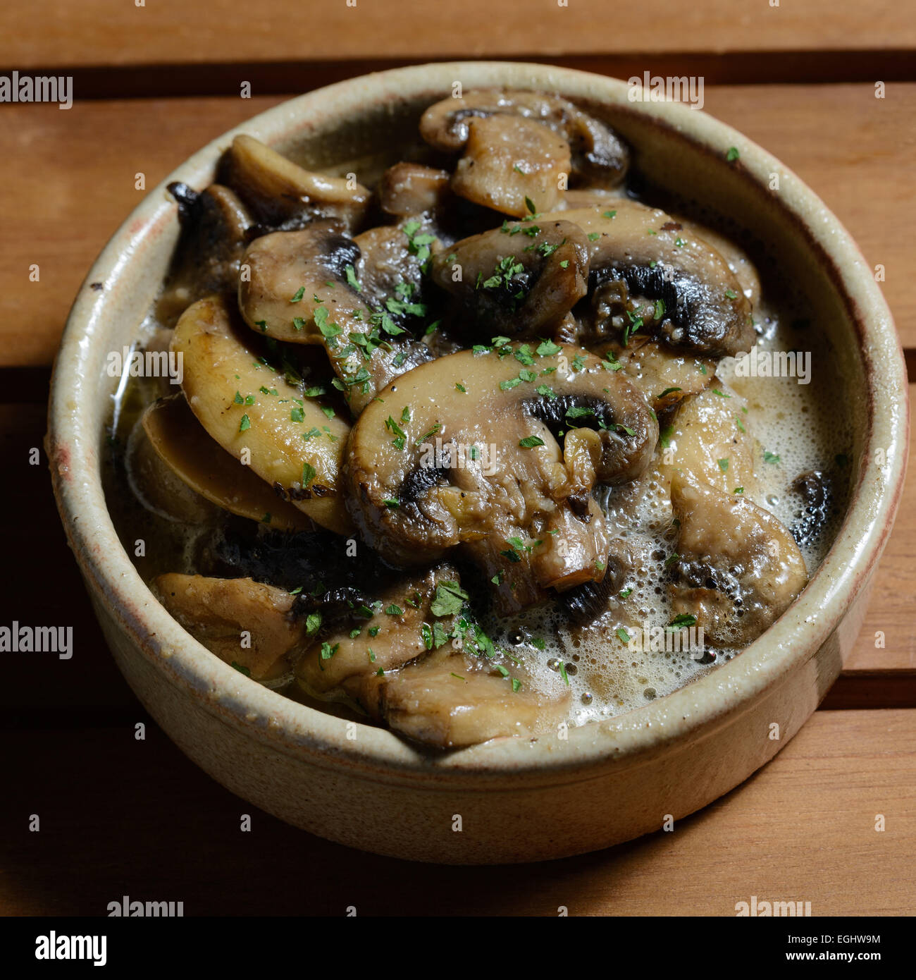 Ajillo. Mushrooms cooked in olive oil and white wine, and flavored with ...