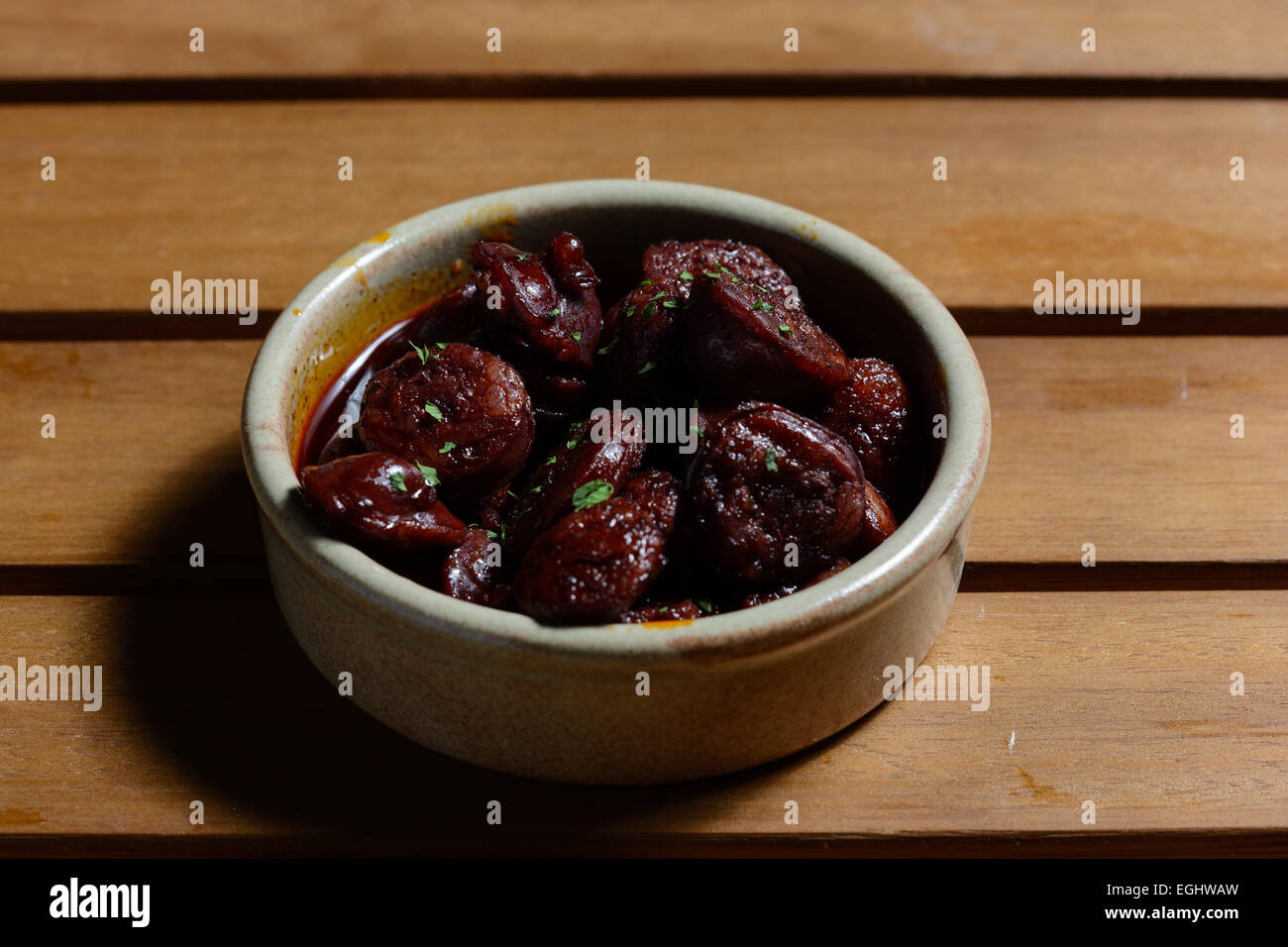 Spicy Chorizo Sausage Cooked in Red Rioja Spanish vine Stock Photo - Alamy