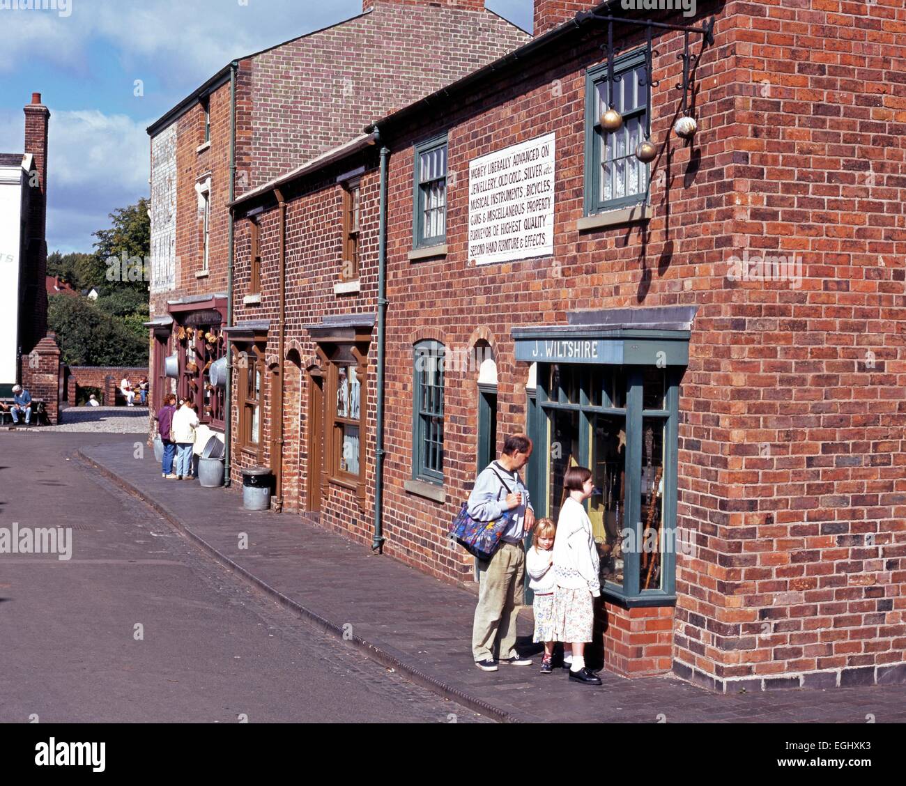 People looking at Victorian shops along the main village shopping ...