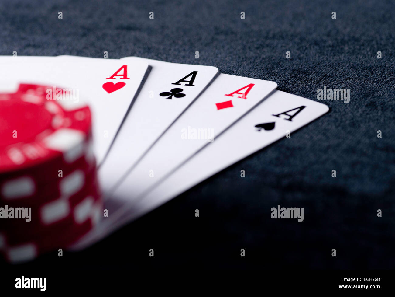 four aces high on black table with chips Stock Photo - Alamy