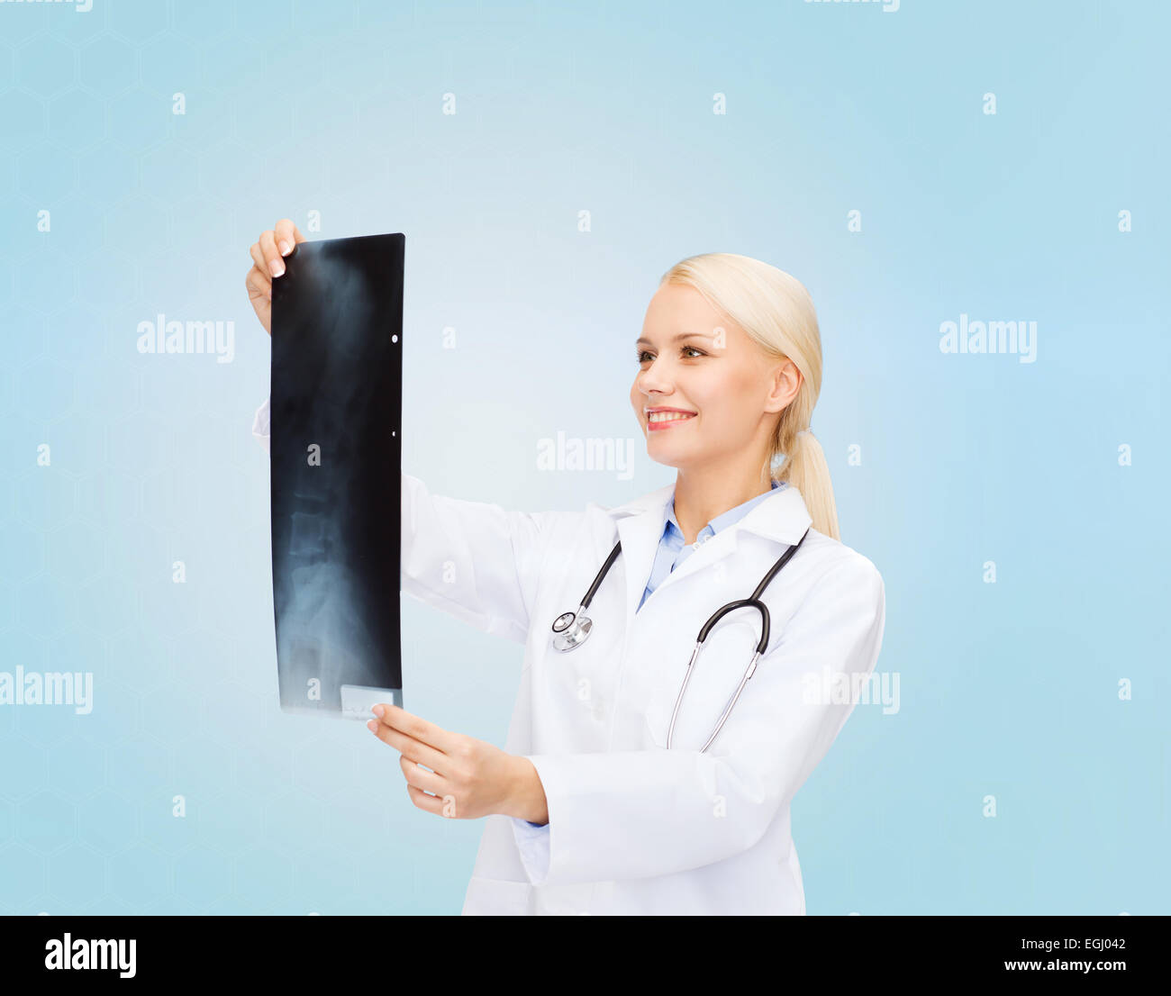 smiling female doctor looking at x-ray image Stock Photo - Alamy