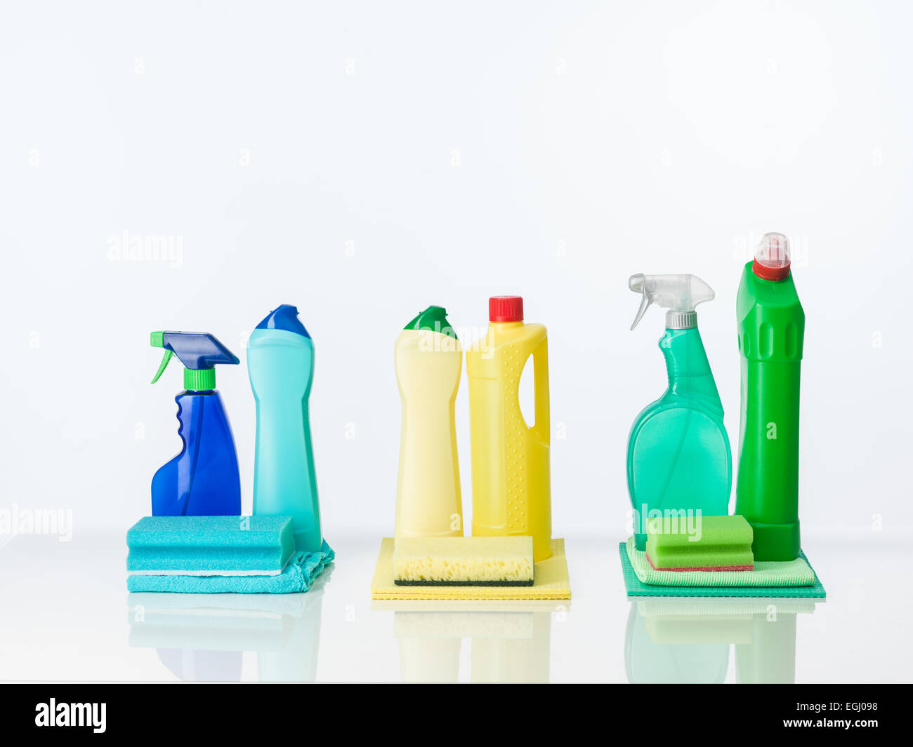 household cleaning supplies arranged by color, on white background ...