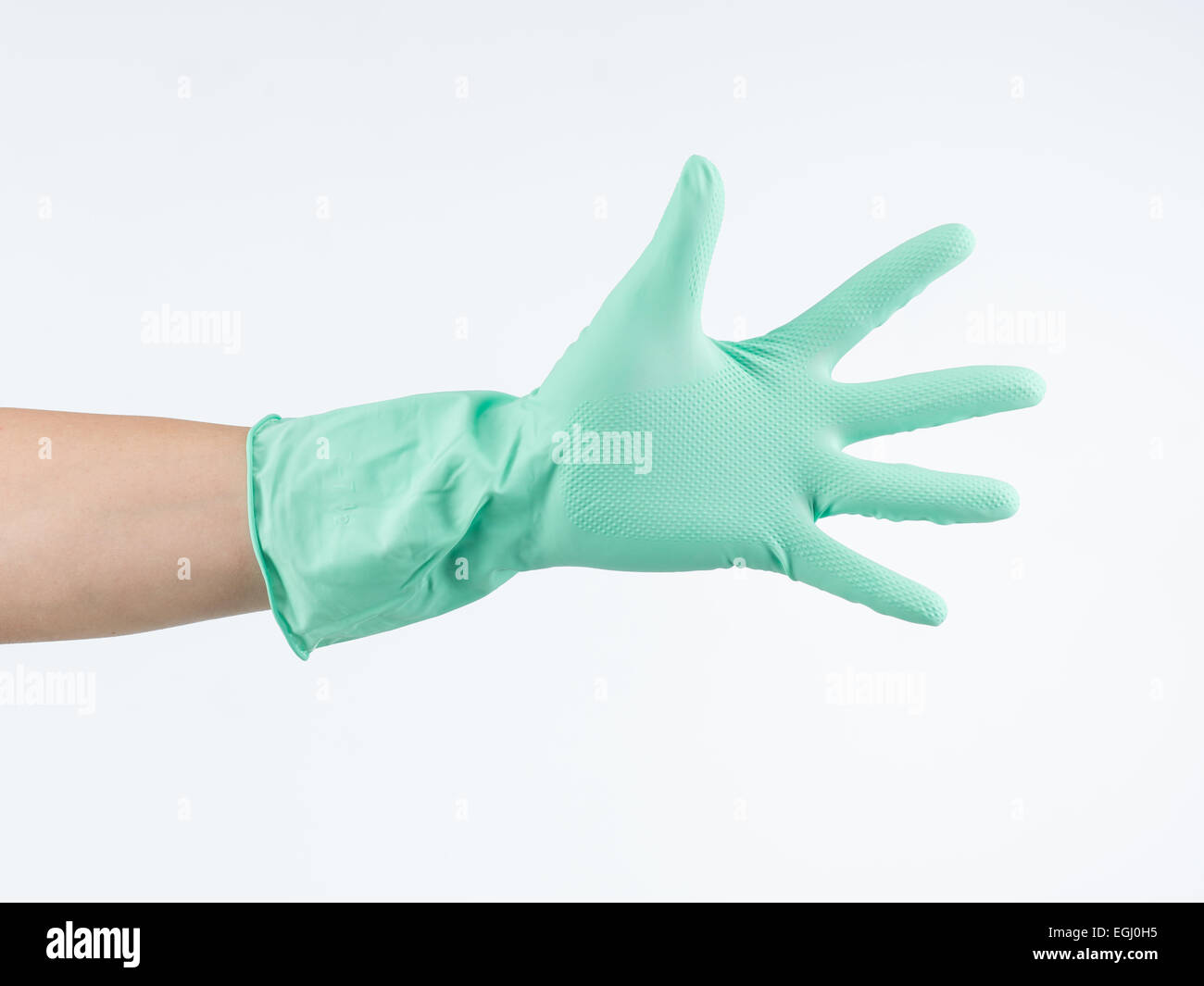 human hand wearing protective rubber glove, showing five fingers, on ...