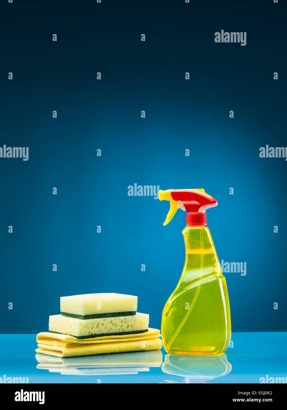 cleaning supplies against blue background Stock Photo - Alamy