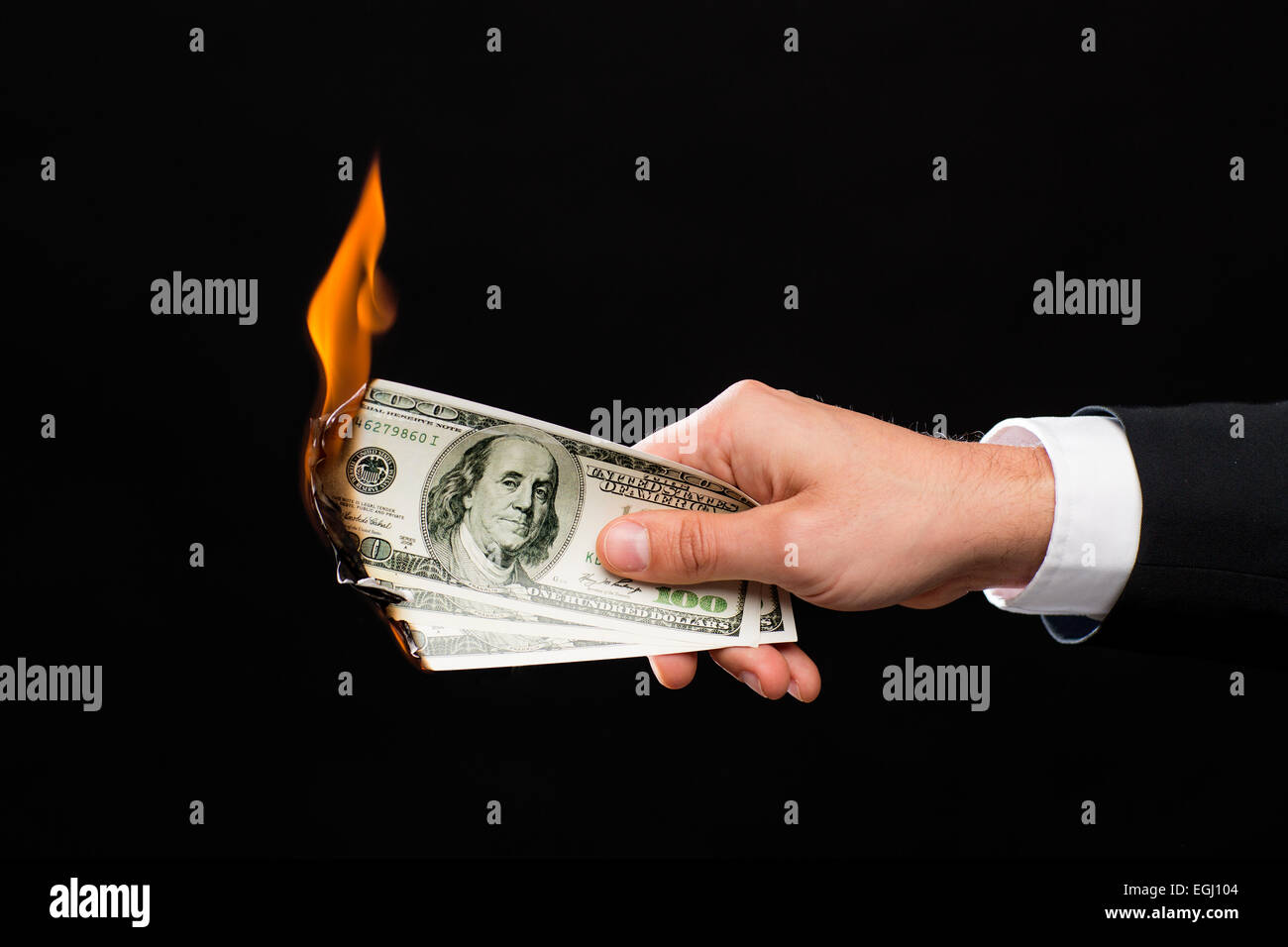 close up of male hand holding burning dollar money Stock Photo - Alamy