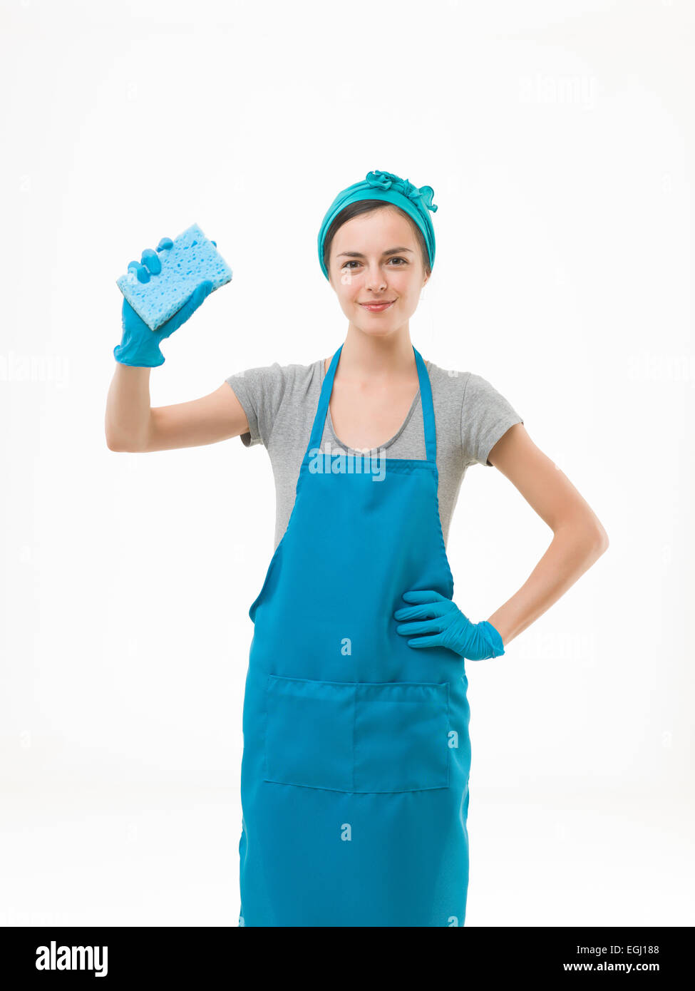 cleaning woman in blue workwear holding sponge, against white ...