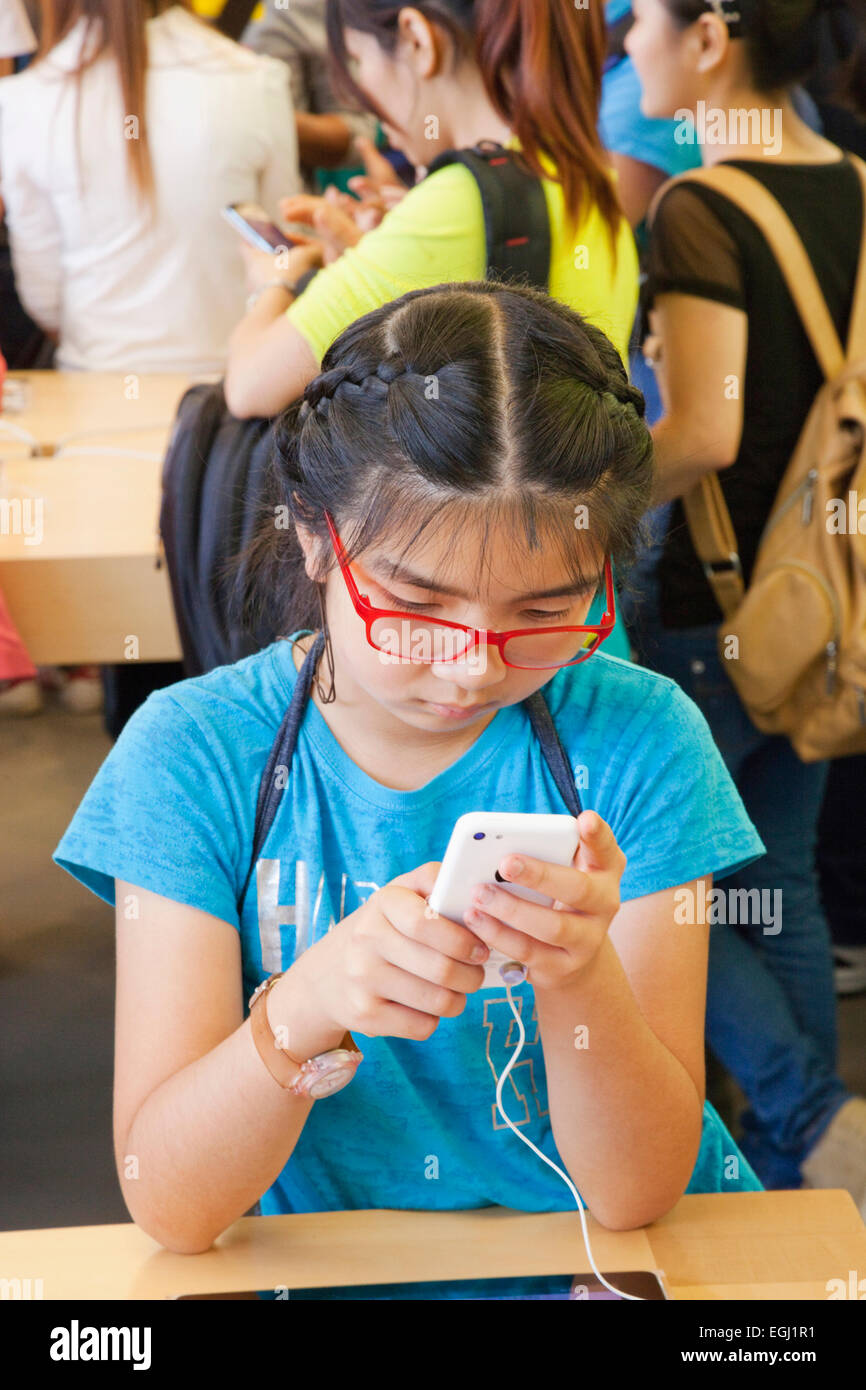 China, Hong Kong, Apple Store, Young Girl Looking at iPhone Stock Photo ...