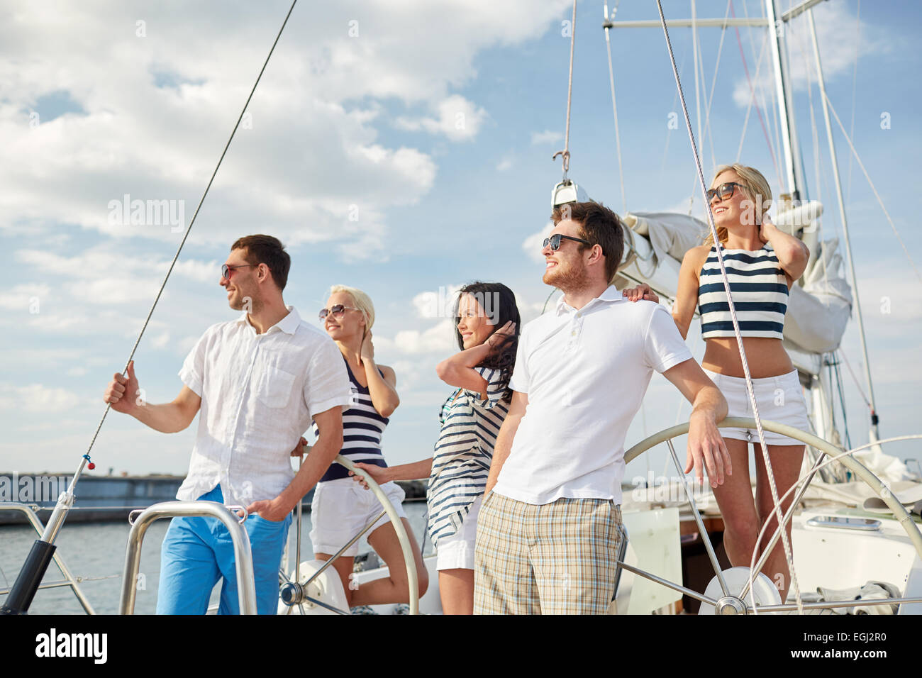 smiling friends sailing on yacht Stock Photo - Alamy