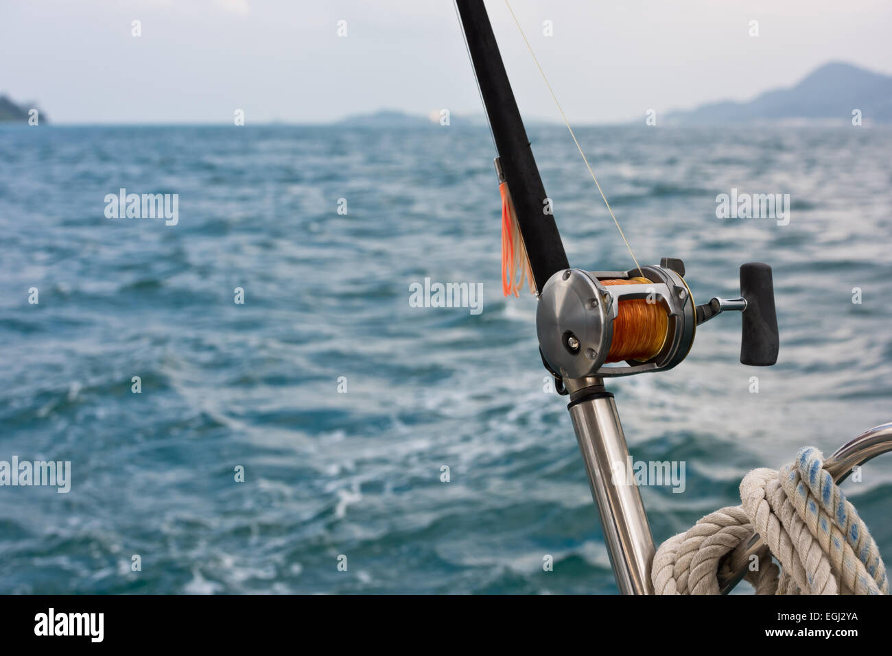 Fishing rod and reel on a boat. Horizontal shot Stock Photo - Alamy
