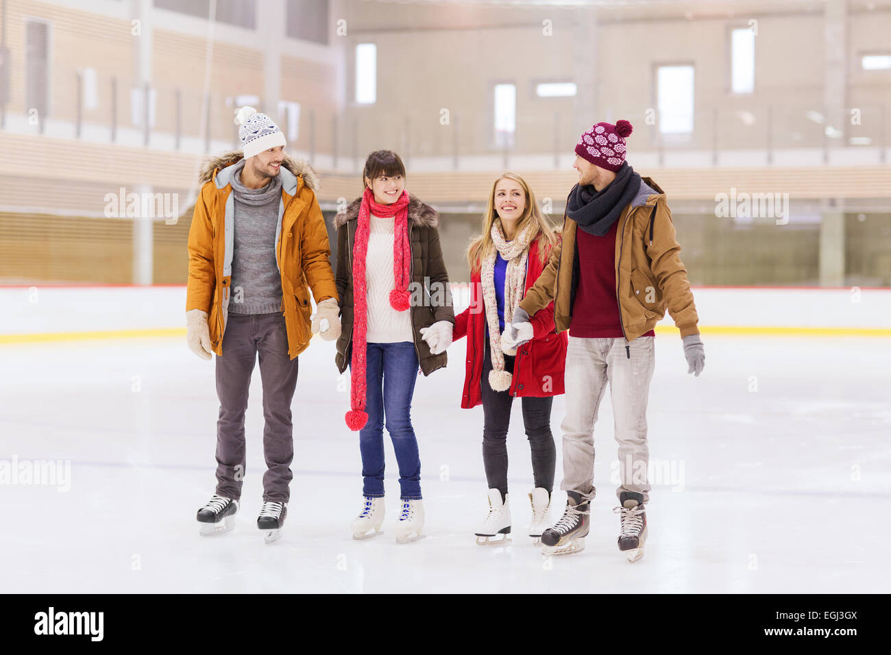 happy friends on skating rink Stock Photo - Alamy