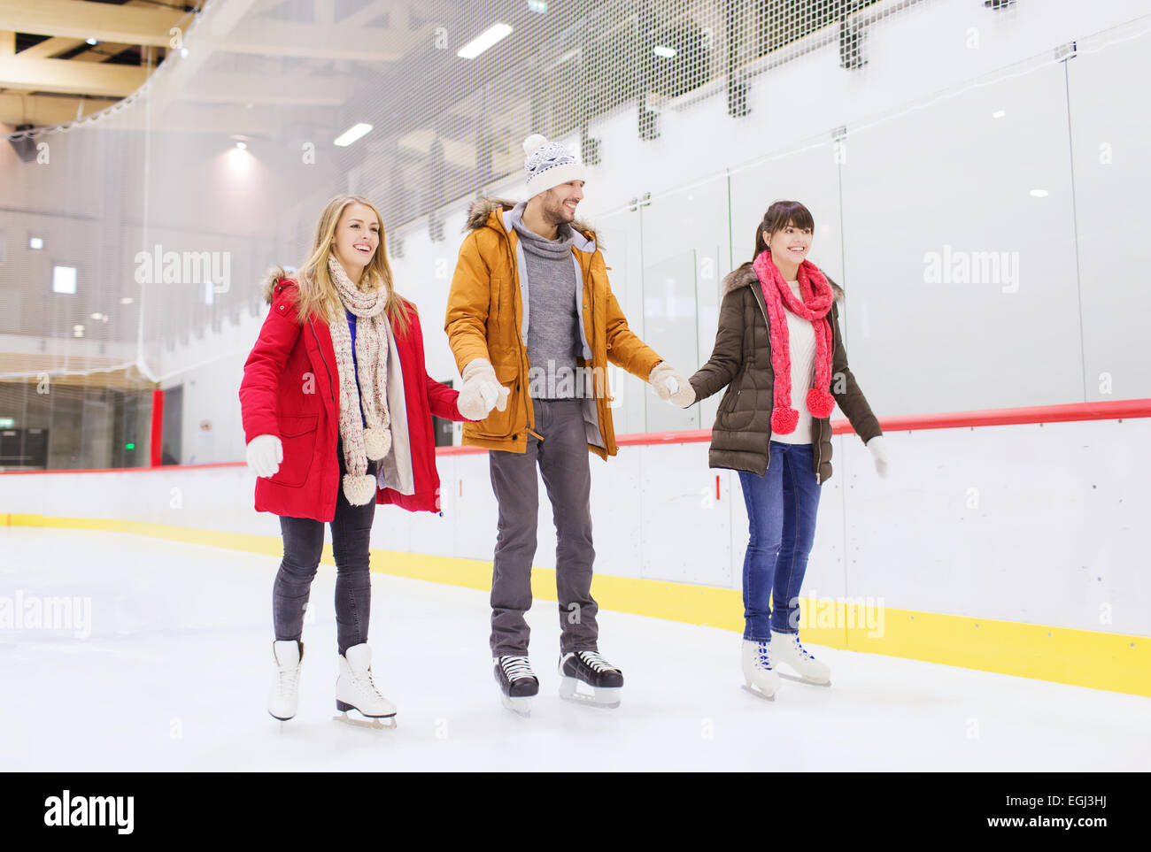 happy friends on skating rink Stock Photo - Alamy