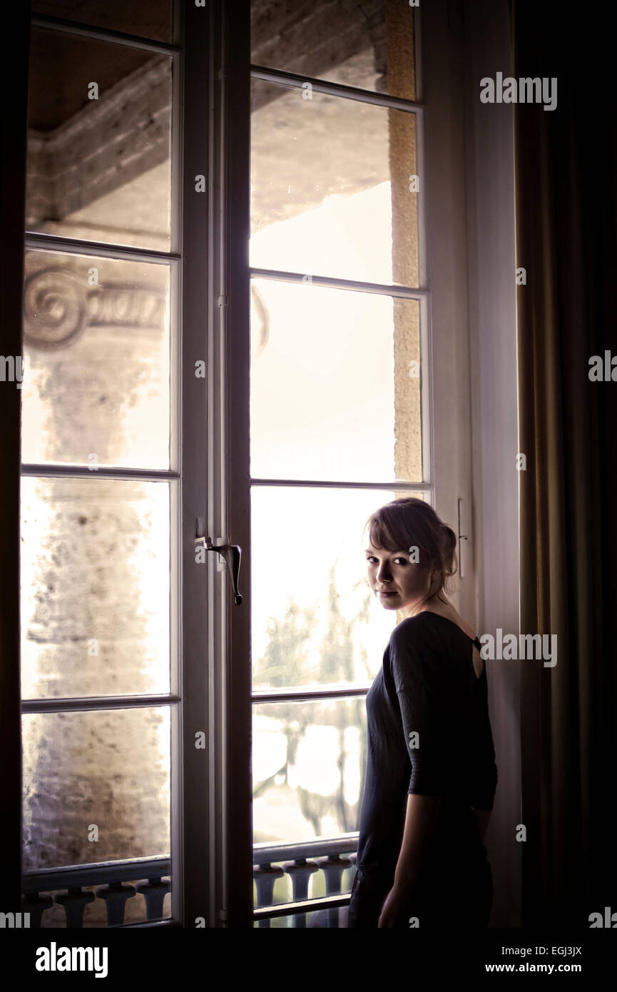Young woman at the window Stock Photo - Alamy