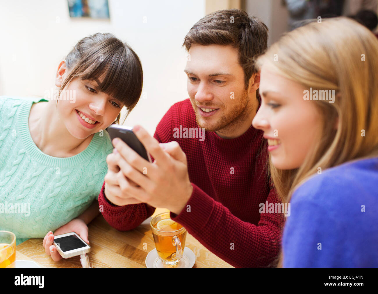 group of friends with smartphones meeting at cafe Stock Photo - Alamy