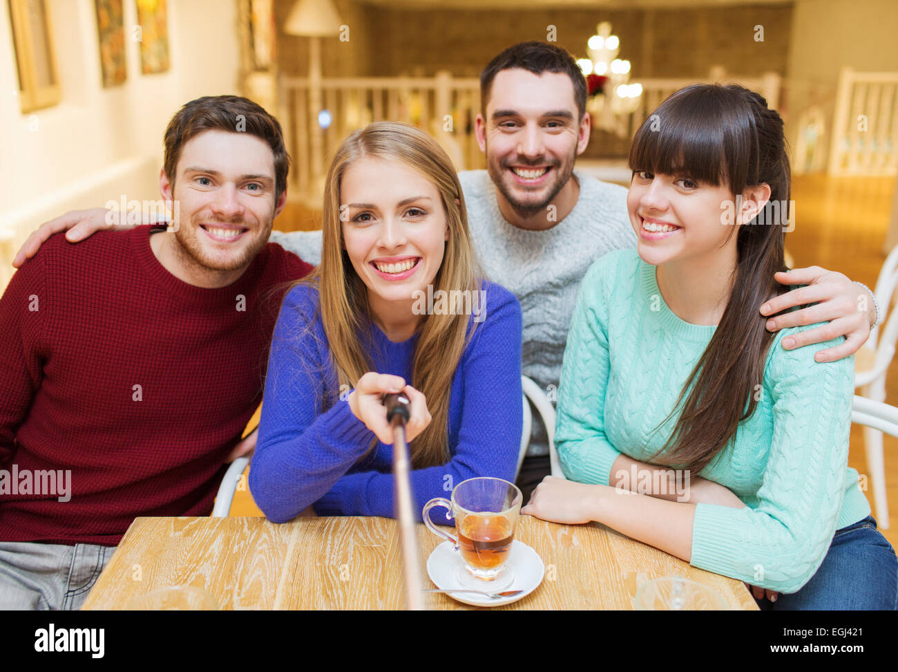 group of friends taking picture with selfie stick Stock Photo - Alamy