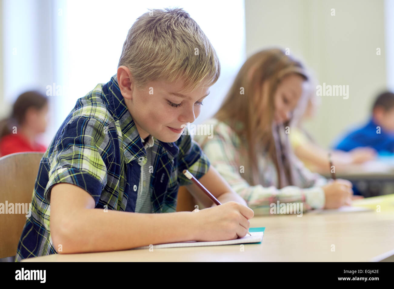 group of school kids writing test in classroom Stock Photo - Alamy