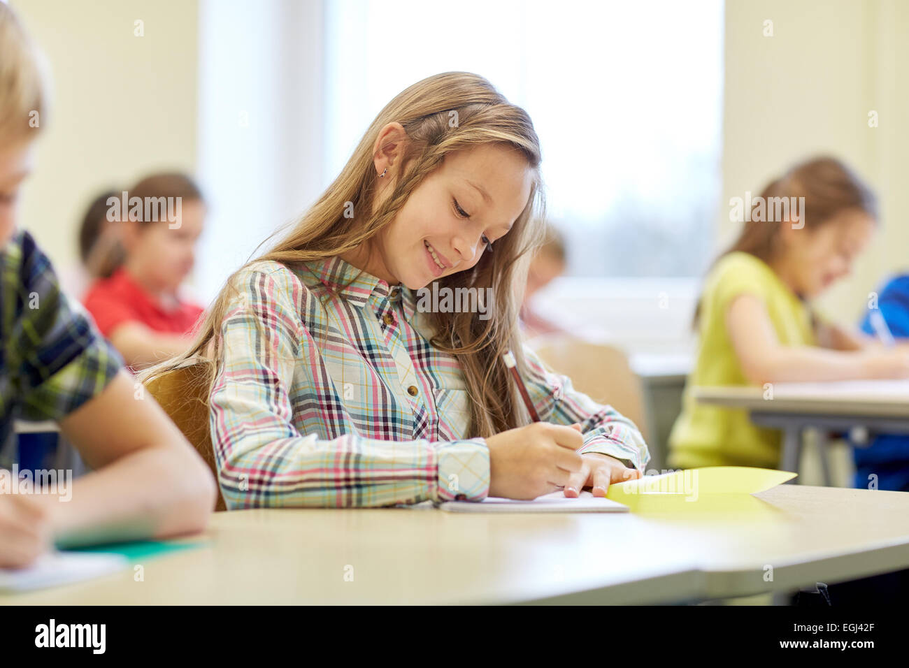 group of school kids writing test in classroom Stock Photo - Alamy