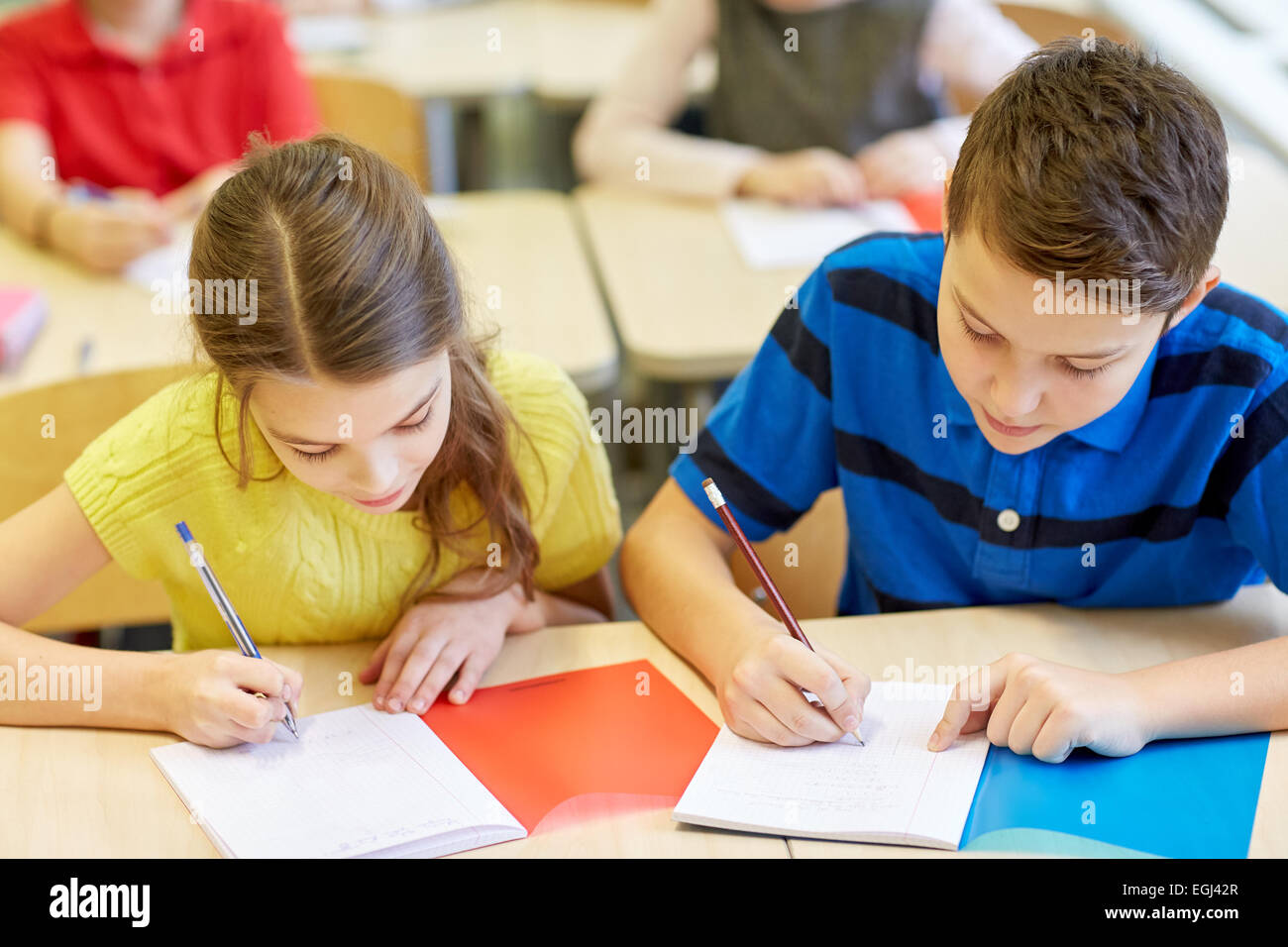 group of school kids writing test in classroom Stock Photo - Alamy