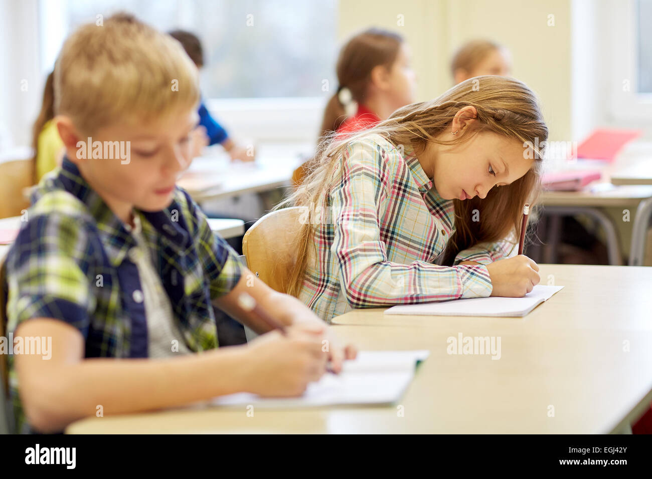 group of school kids writing test in classroom Stock Photo - Alamy