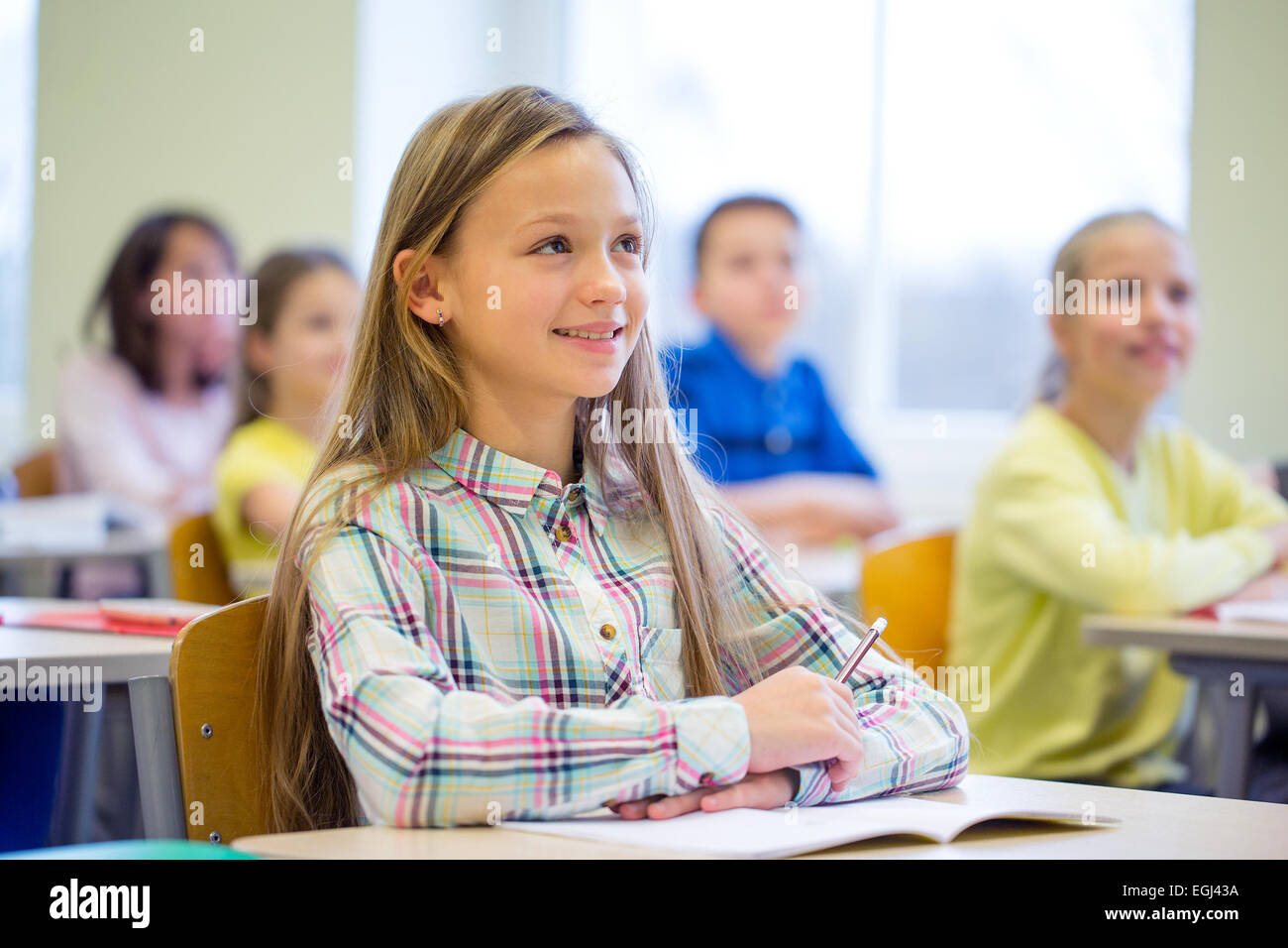 group of school kids with notebooks in classroom Stock Photo - Alamy