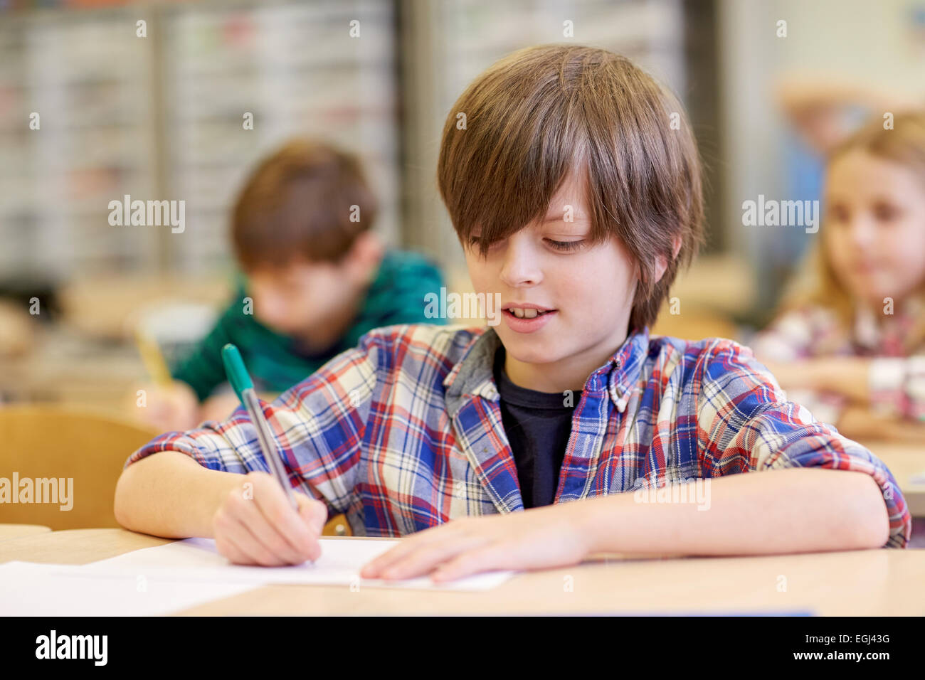 group of school kids writing test in classroom Stock Photo - Alamy