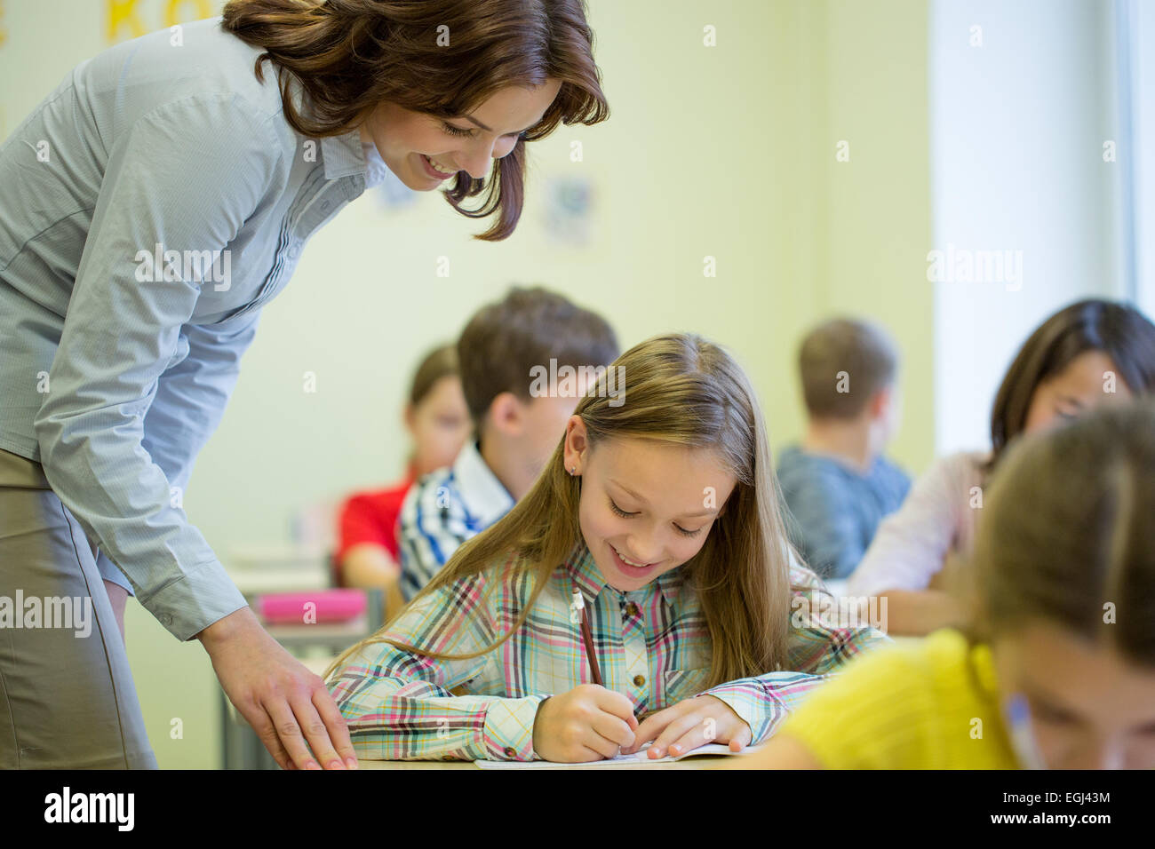 group of school kids writing test in classroom Stock Photo - Alamy