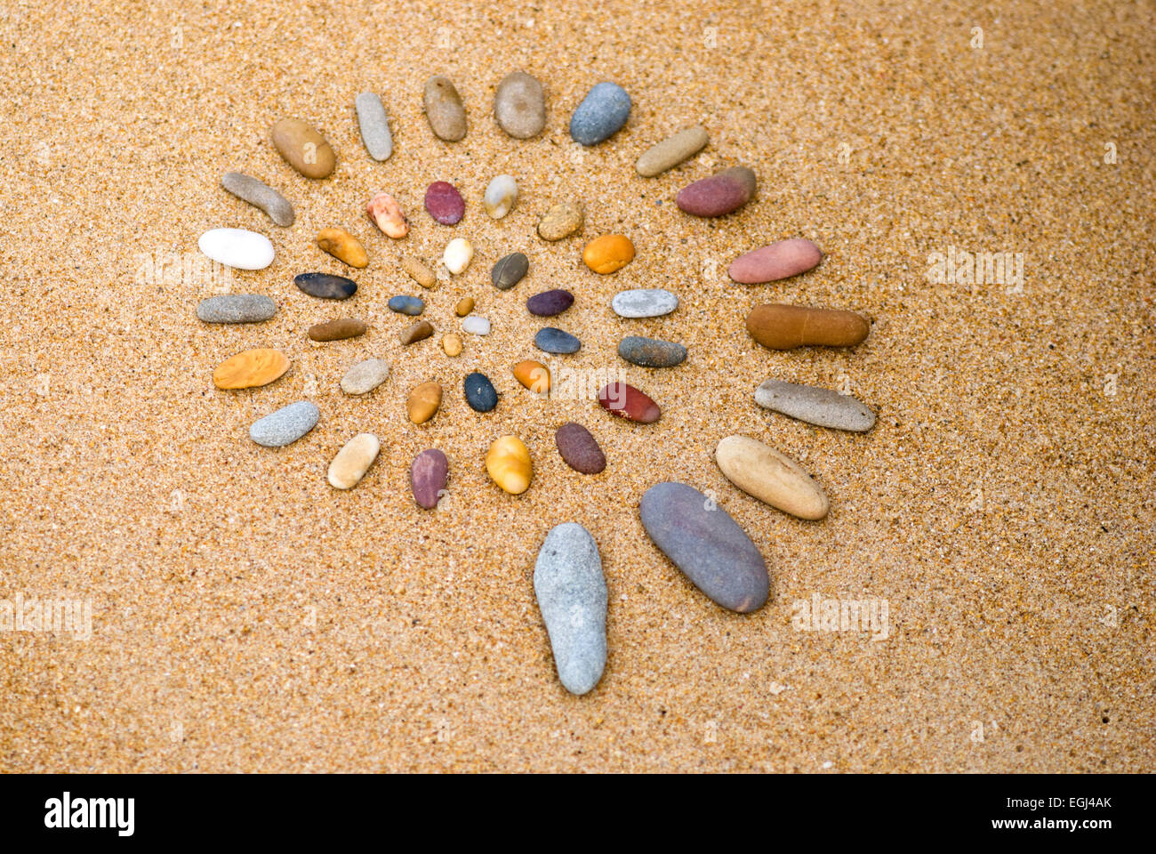Spiral of pebble stones in the sand Stock Photo - Alamy