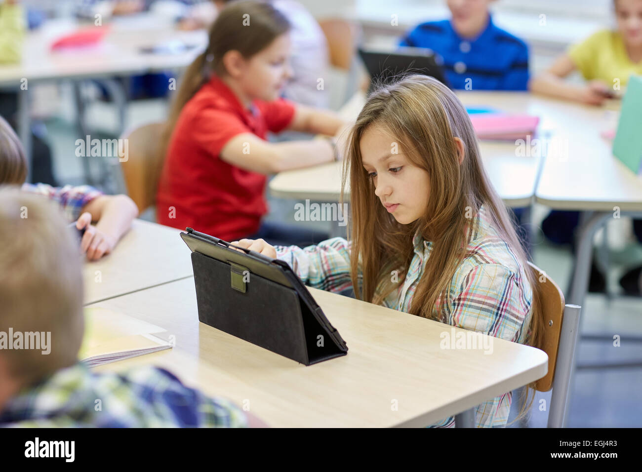 school kids with tablet pc in classroom Stock Photo - Alamy