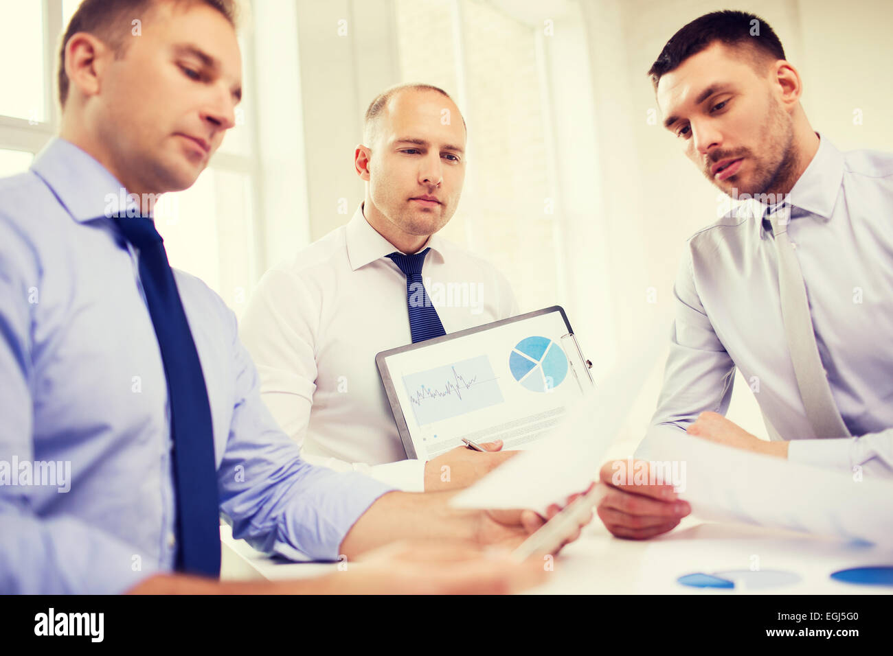 serious businessmen with papers in office Stock Photo - Alamy